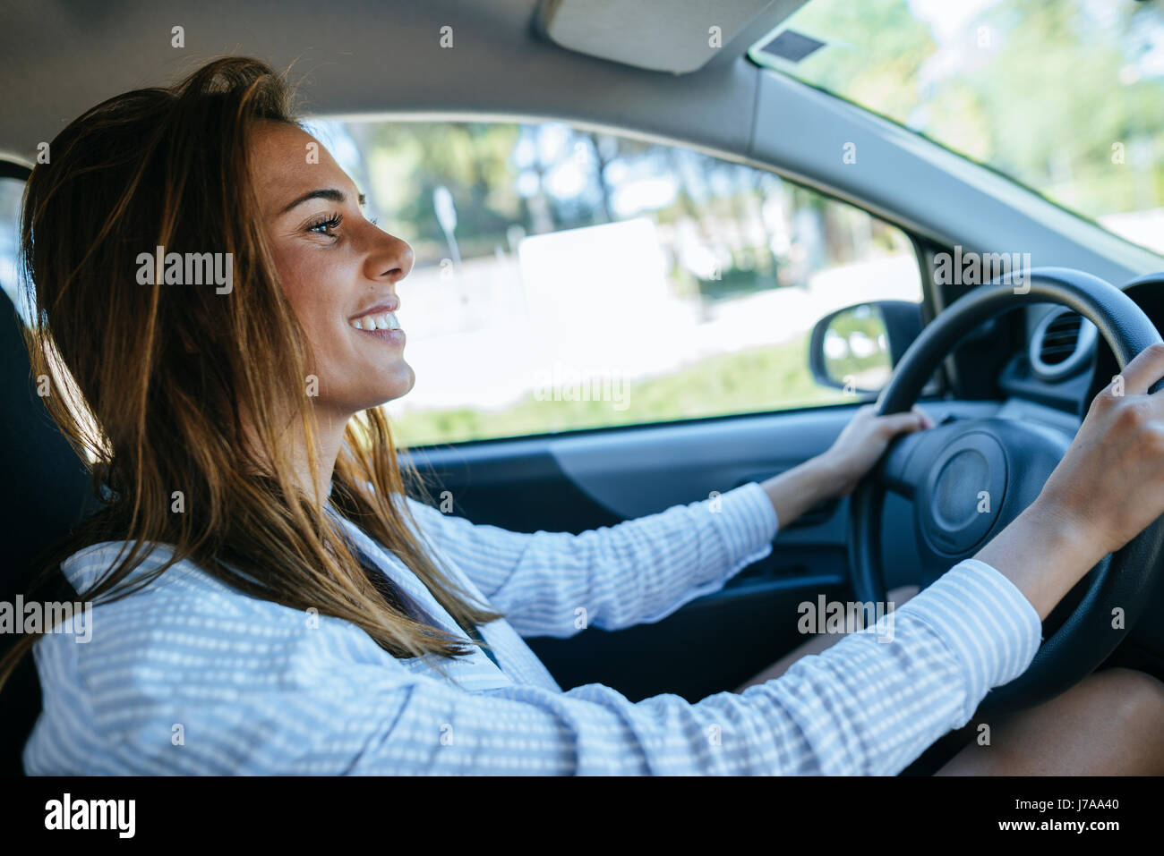 Smiling woman driving car Stock Photo - Alamy