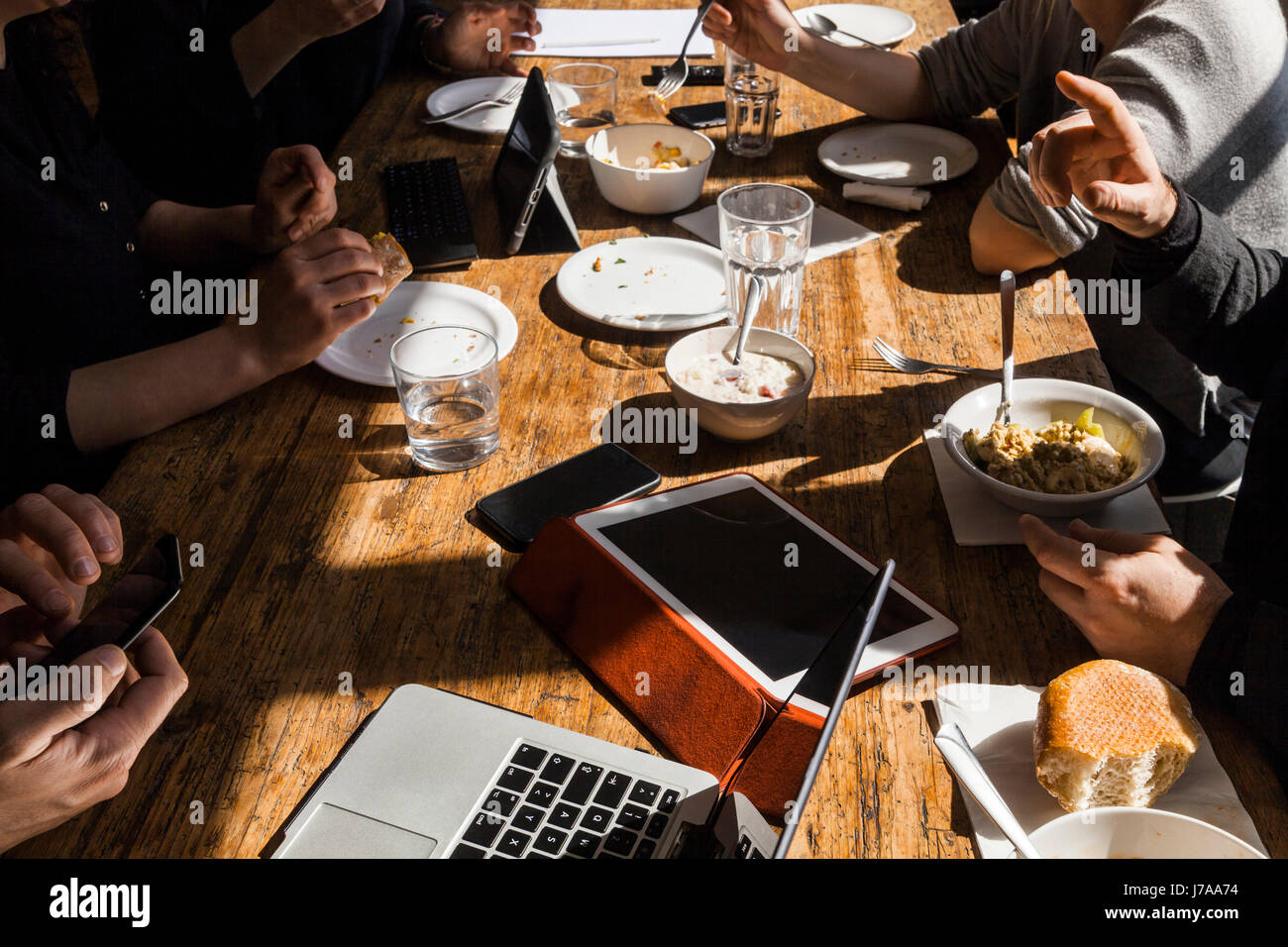 Colleagues having lunch together in the office, partial view Stock ...