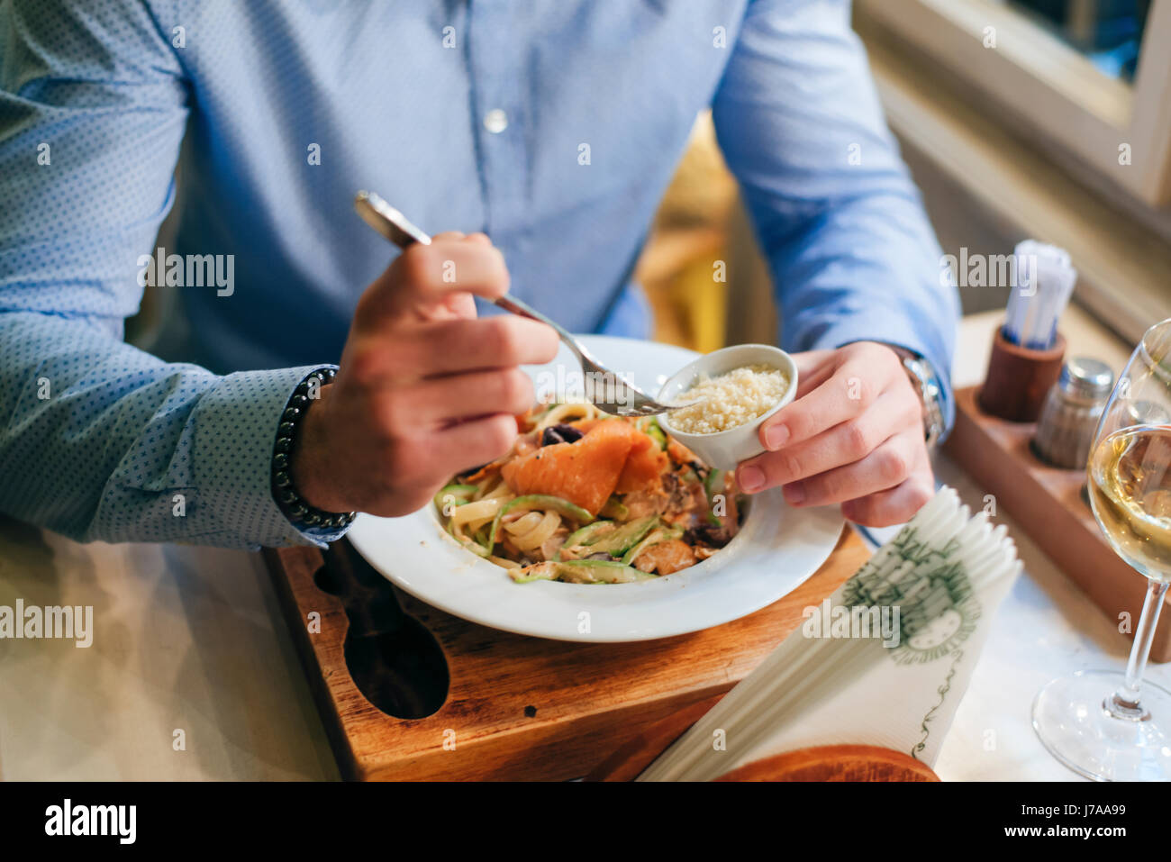 Man having dinner in a restaurant, partial view Stock Photo - Alamy