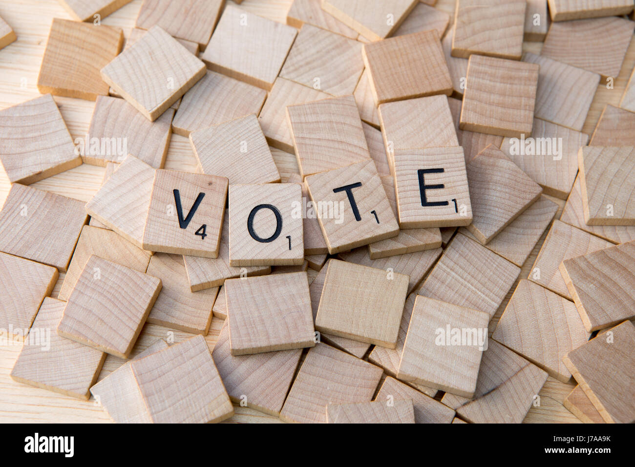 Vote . spelt with scrabble letters on wood tiles Stock Photo - Alamy