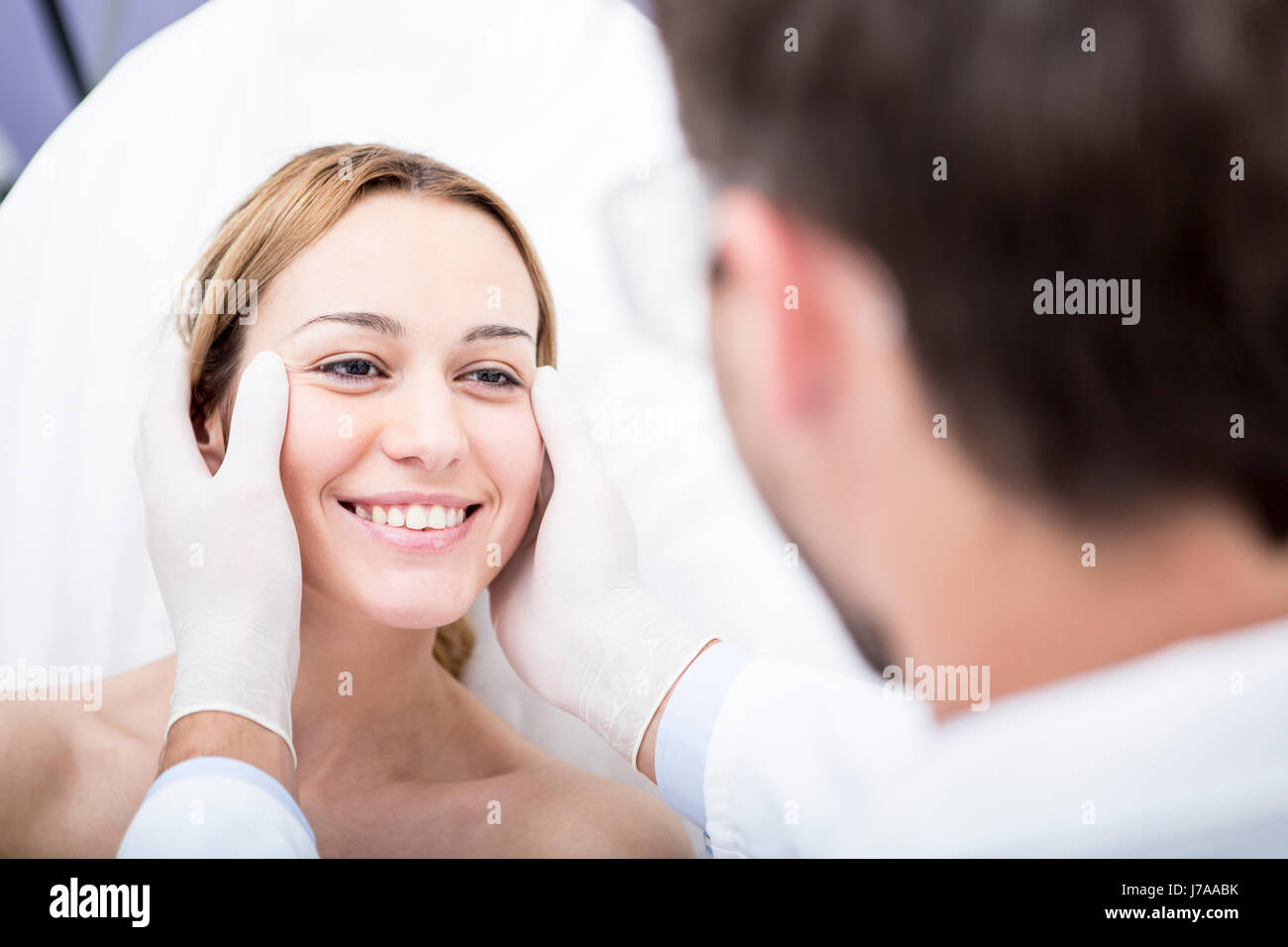 Aesthetic surgery, doctor looking at woman Stock Photo - Alamy