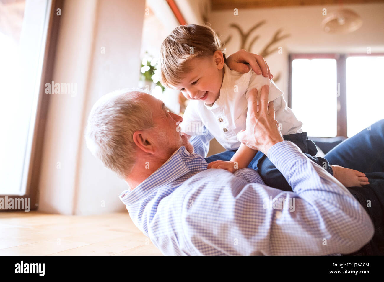 Grandfather and grandson having fun at home Stock Photo - Alamy