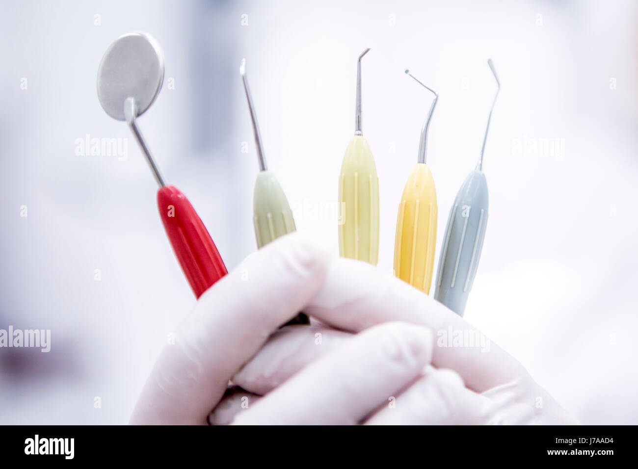 Hand holding dental instruments Stock Photo - Alamy