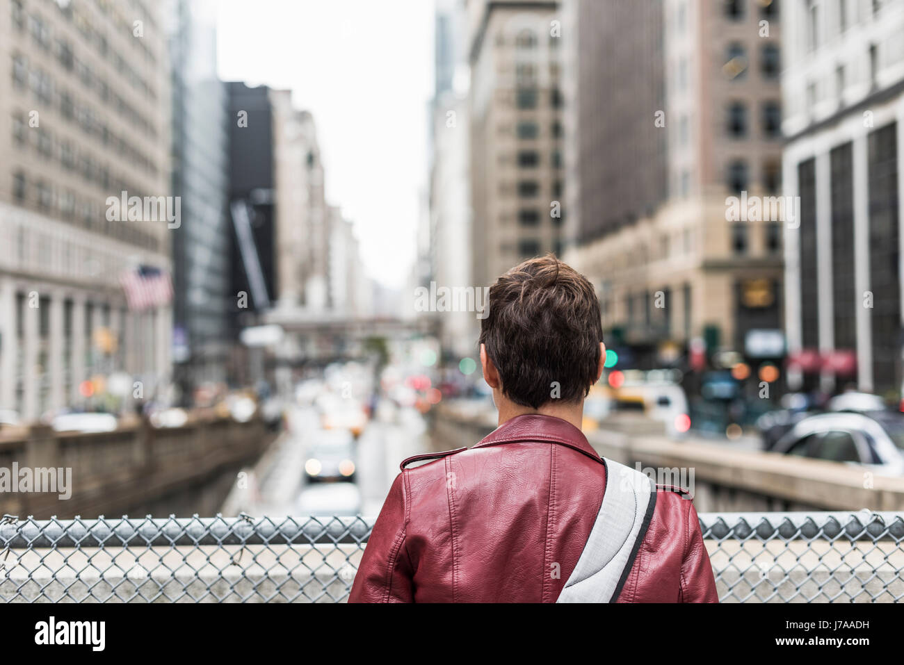 USA, New York City, rear view of woman on bridge in the city Stock ...