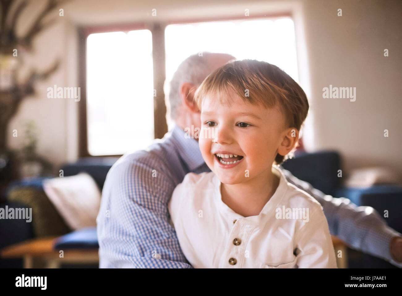 Grandfather and grandson having fun at home Stock Photo - Alamy
