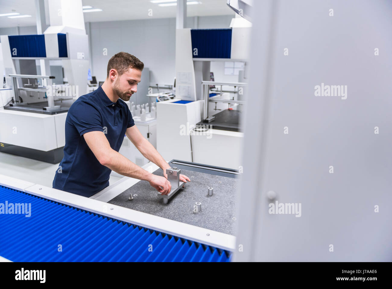 Man at a machine in testing instrument room Stock Photo - Alamy