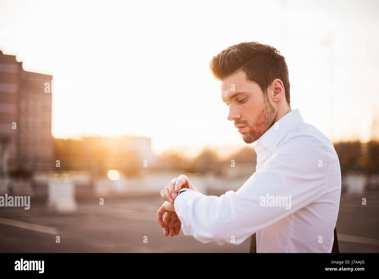 Young man checking the time Stock Photo - Alamy