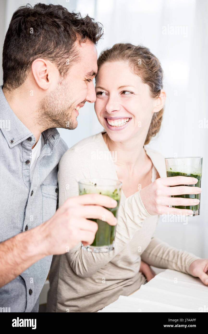 Happy couple drinking smoothie together Stock Photo - Alamy