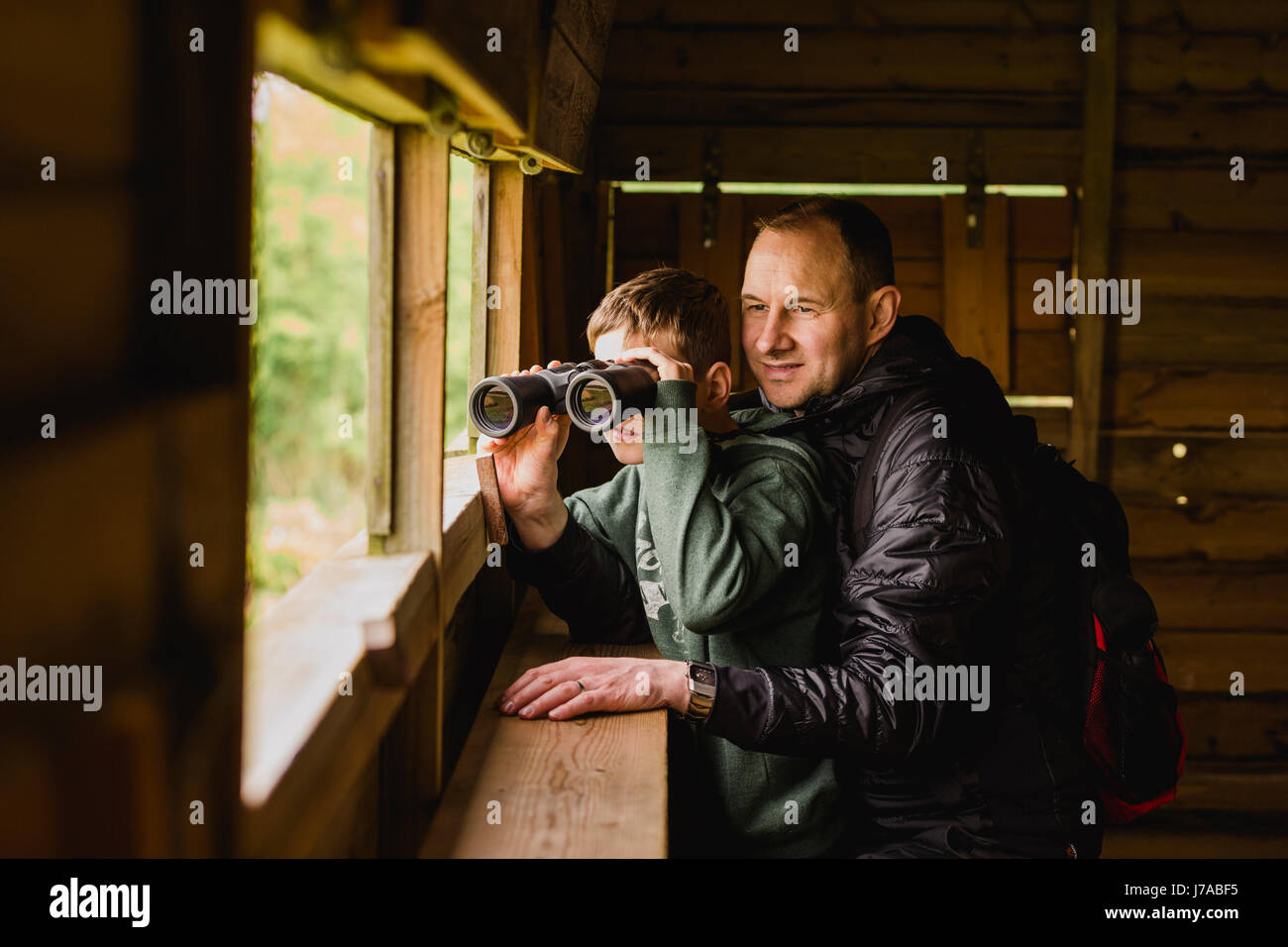 Boy and father birdwatching with binoculars Stock Photo - Alamy