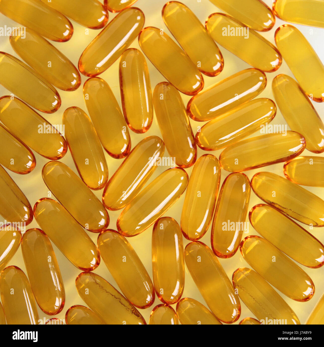 Fish oil tablets as background Stock Photo - Alamy
