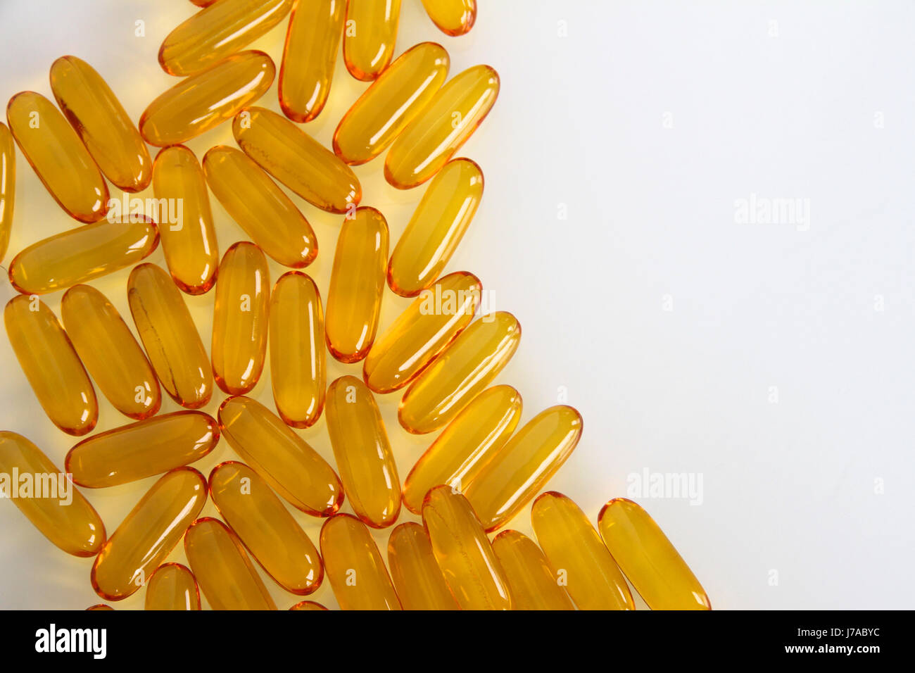 Fish oil tablets as background Stock Photo - Alamy
