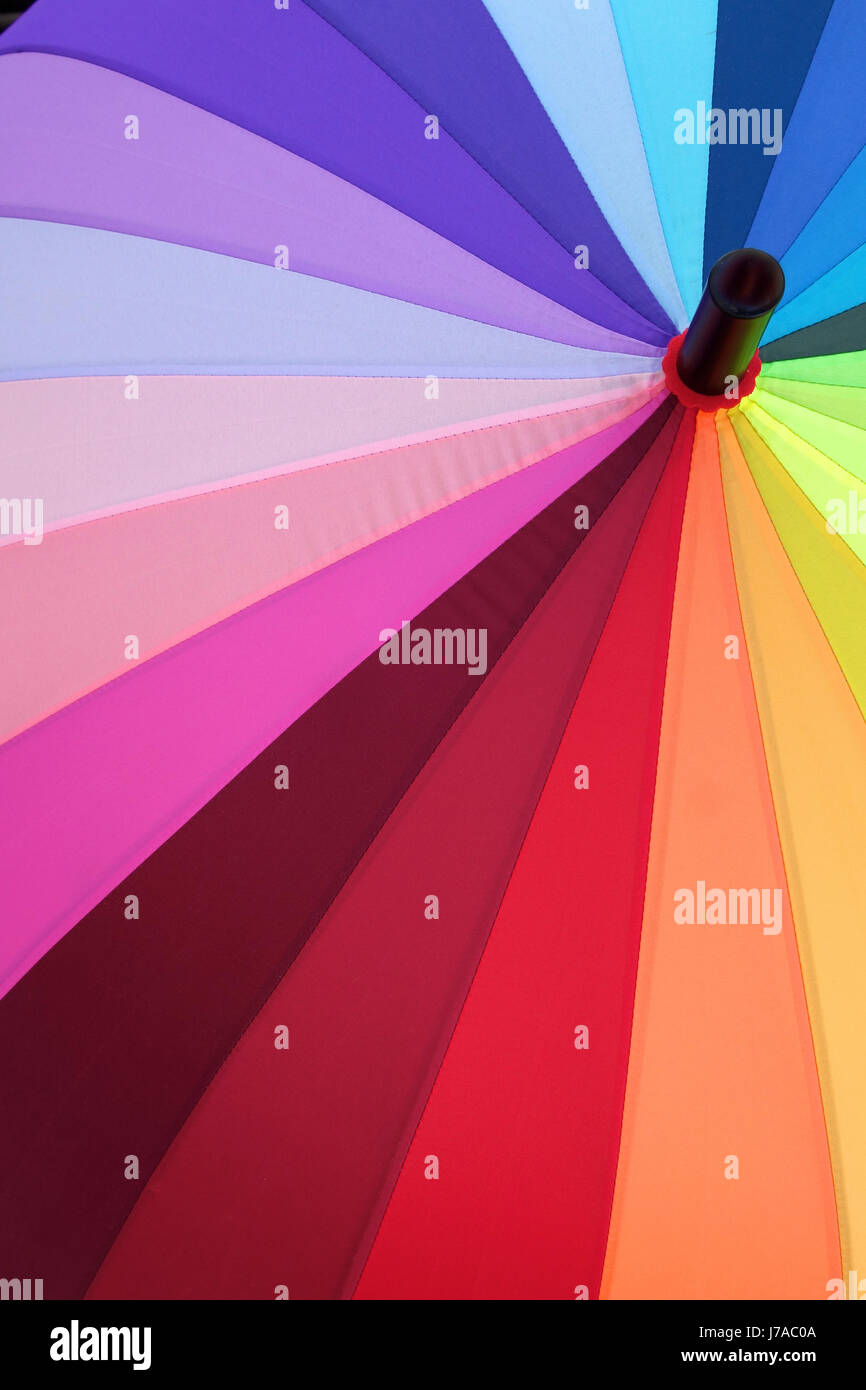 A multi coloured umbrella showing a spectrum of colour Stock Photo - Alamy