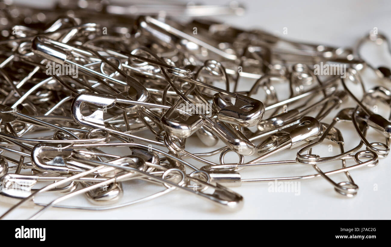 Pile of metal safety pins as background Stock Photo - Alamy