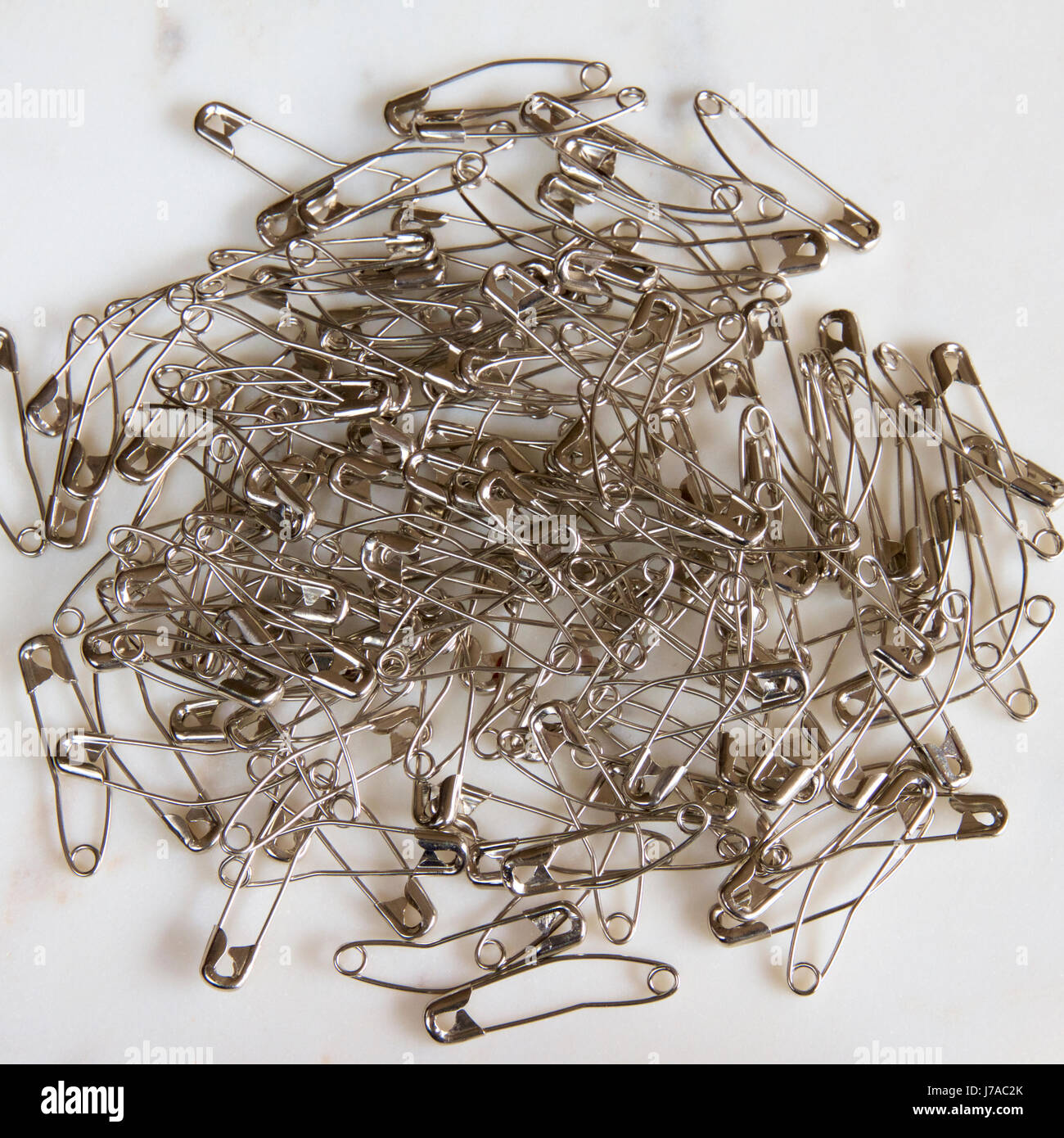 Pile of metal safety pins as background Stock Photo - Alamy