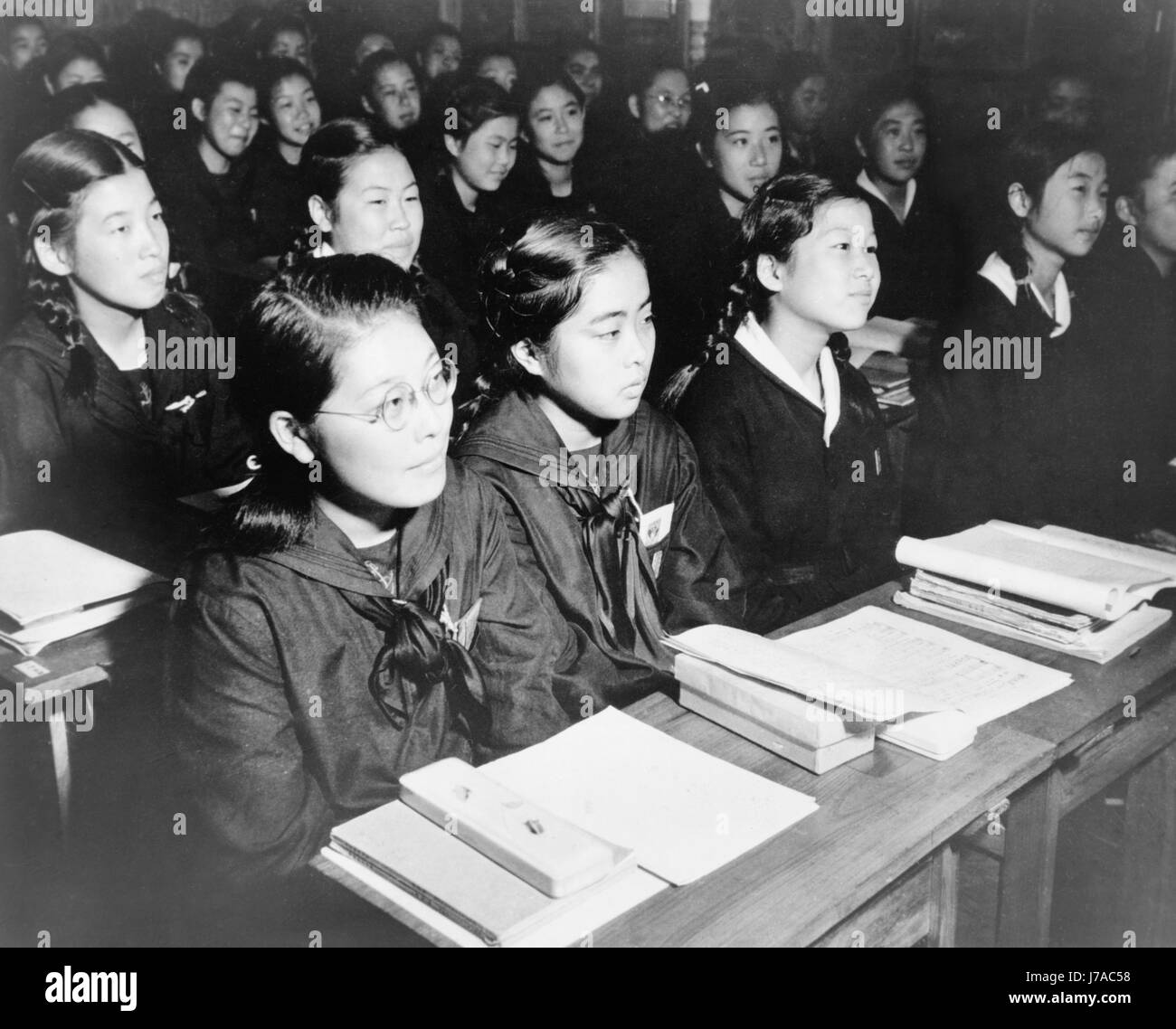 Japanese children seated at desks in a school in Tokyo, Japan, 1946 ...