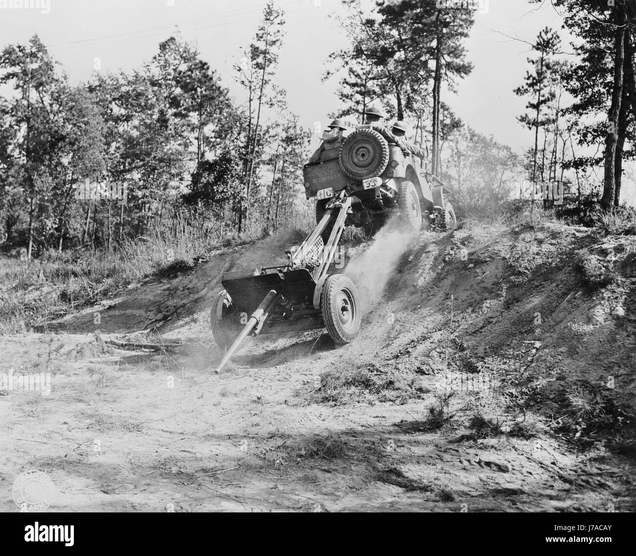 Jeep pulling a 37mm anti-tank gun across rough terrain, 1941 Stock ...