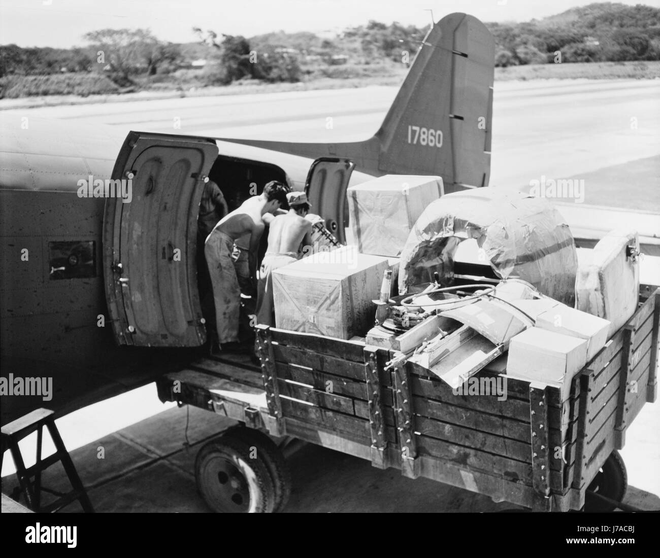 A plane of the United States Army air transport command being loaded ...