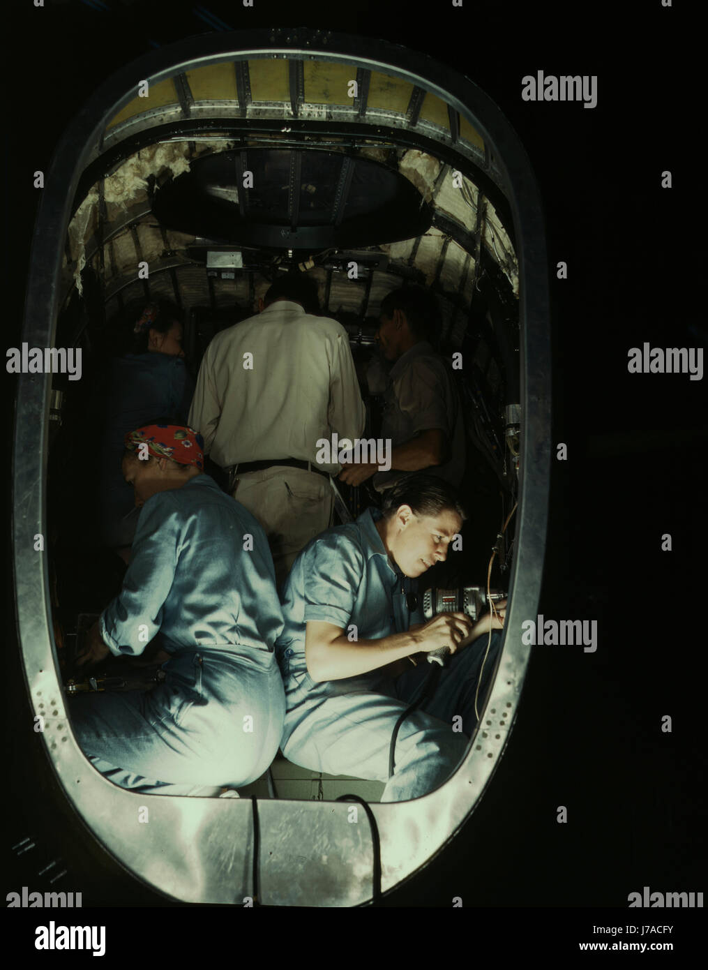 People working inside fuselage of a Liberator Bomber, 1942 Stock Photo ...