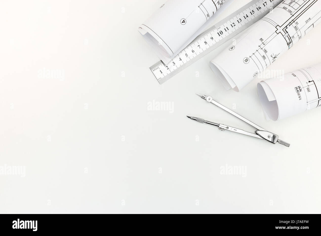 rolls with architectural plans and schemes with drawing compass and ...