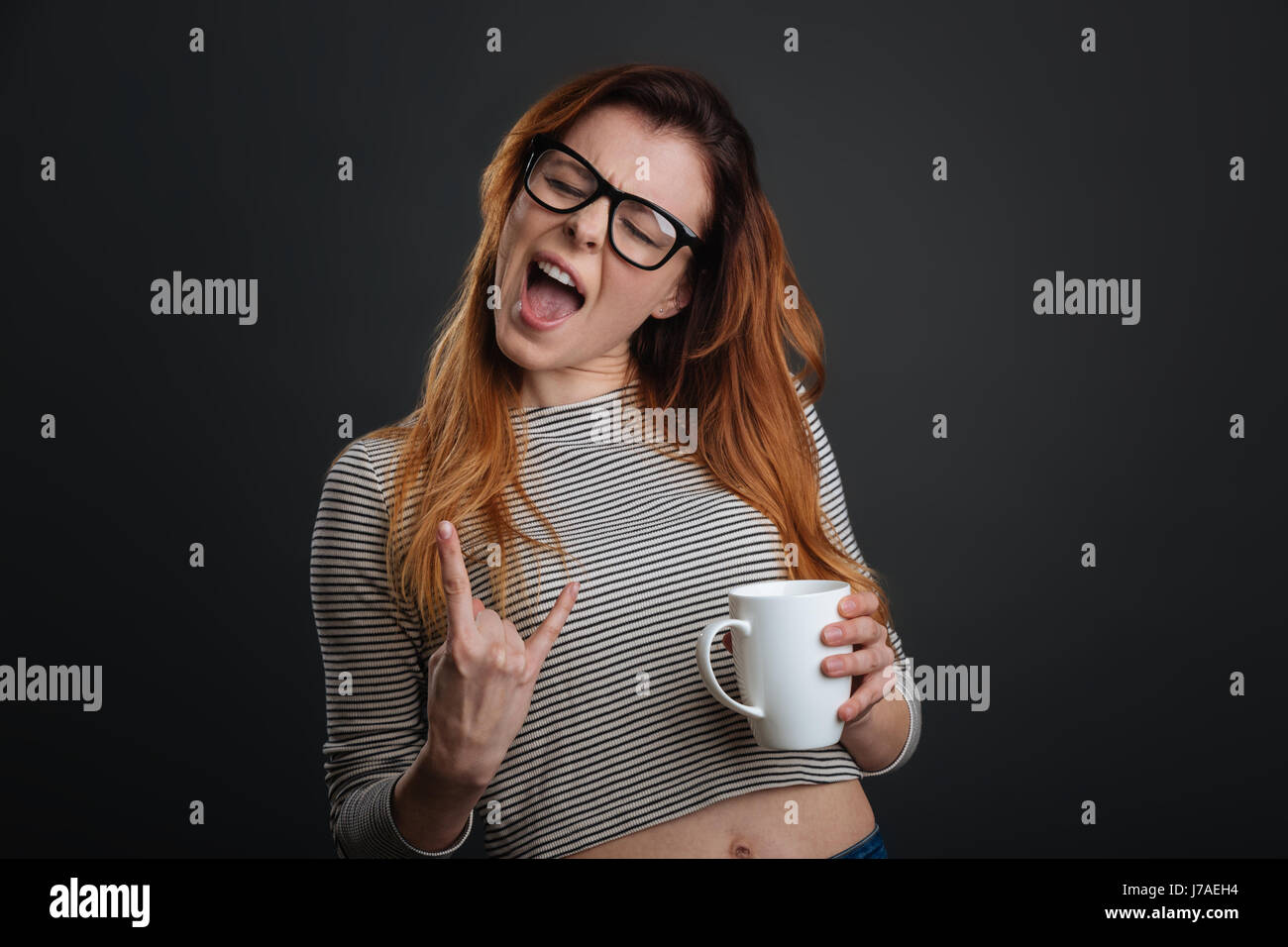 Confident active girl rocking morning coffee Stock Photo - Alamy