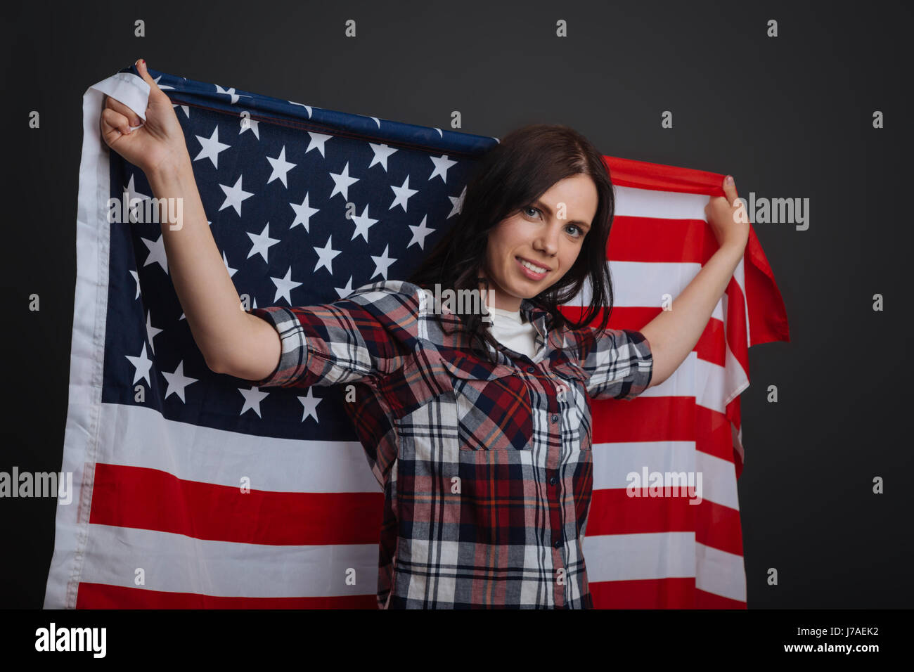 Loyal citizen holding up the national flag Stock Photo - Alamy