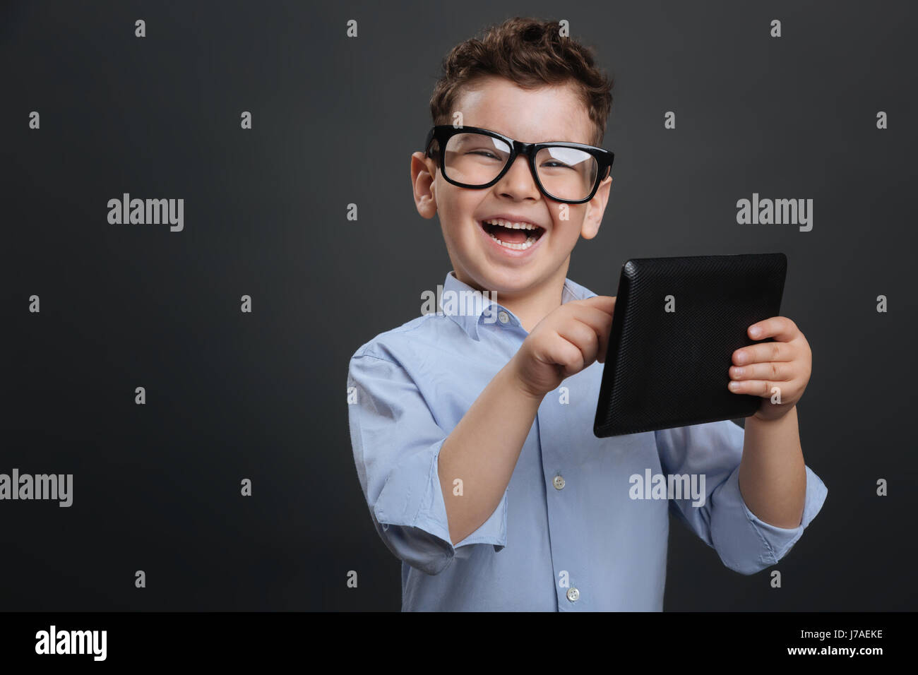 Adorable excited kid fascinated about technology Stock Photo - Alamy