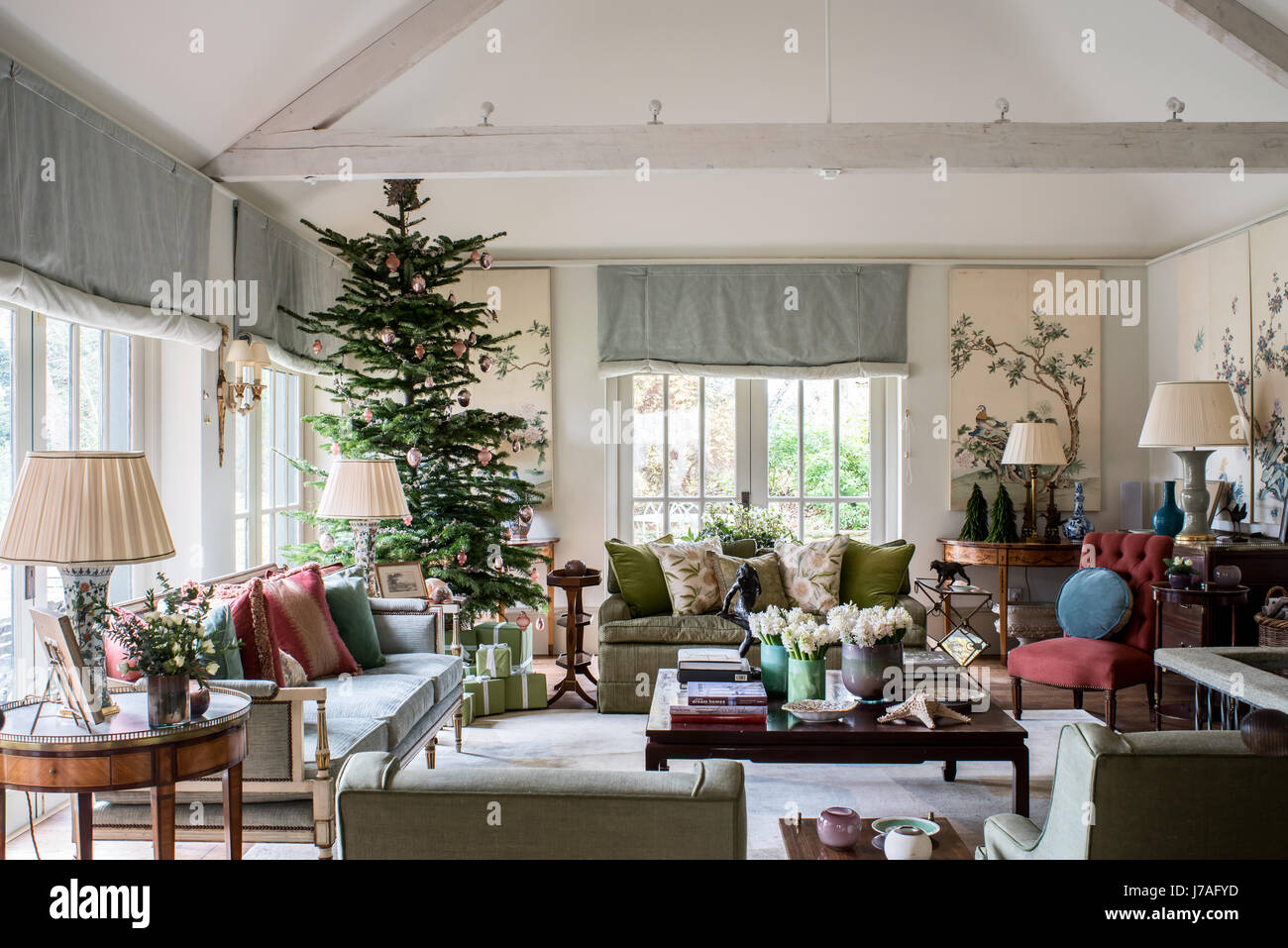 Spacious and light filled living room with old Chinese painted panels ...