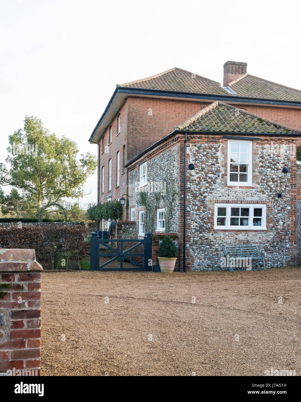 Exterior facade of old flint dairy attached to a three-storey Georgian ...