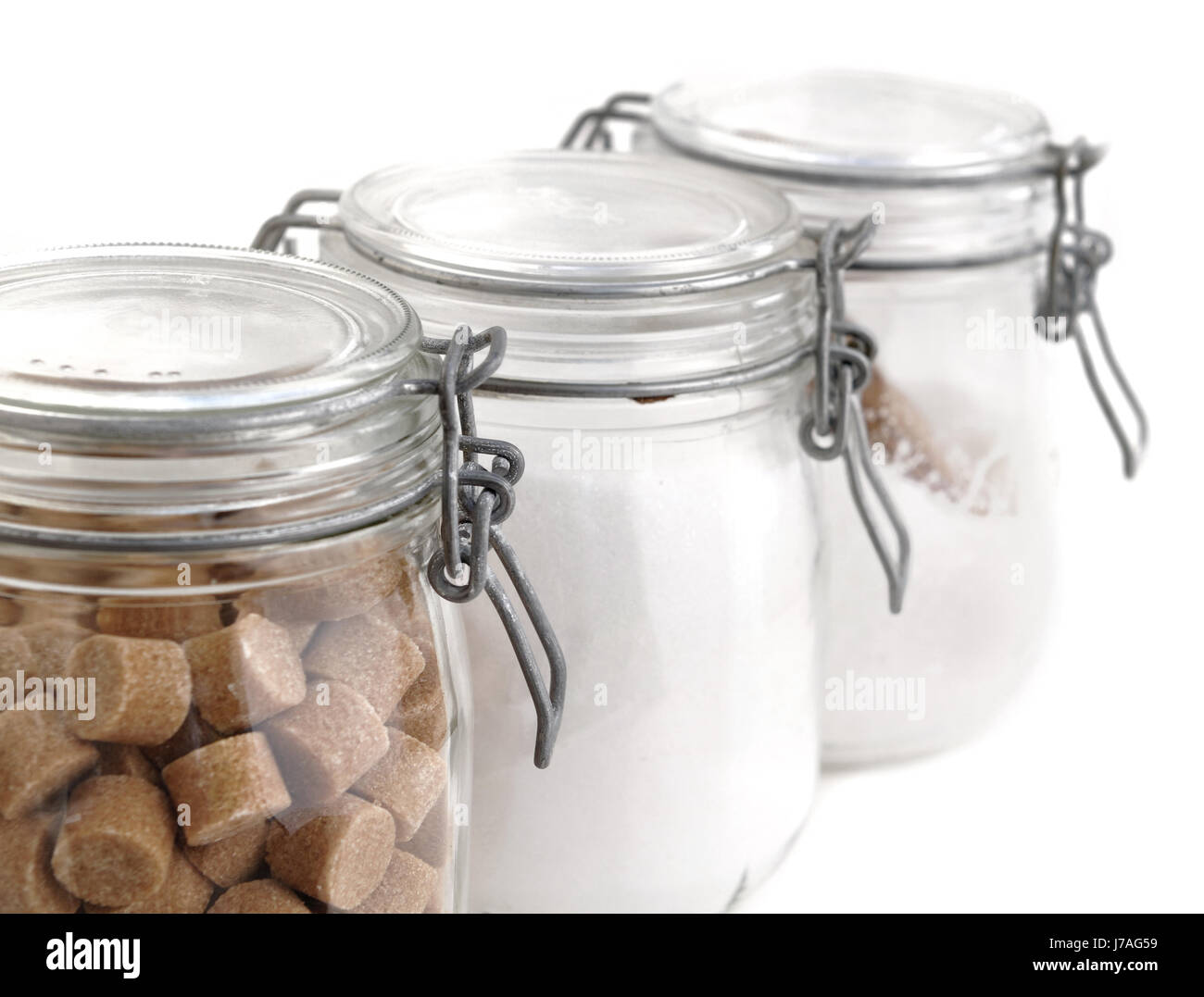 close on food ingredient in glass jars with metal closure on white ...