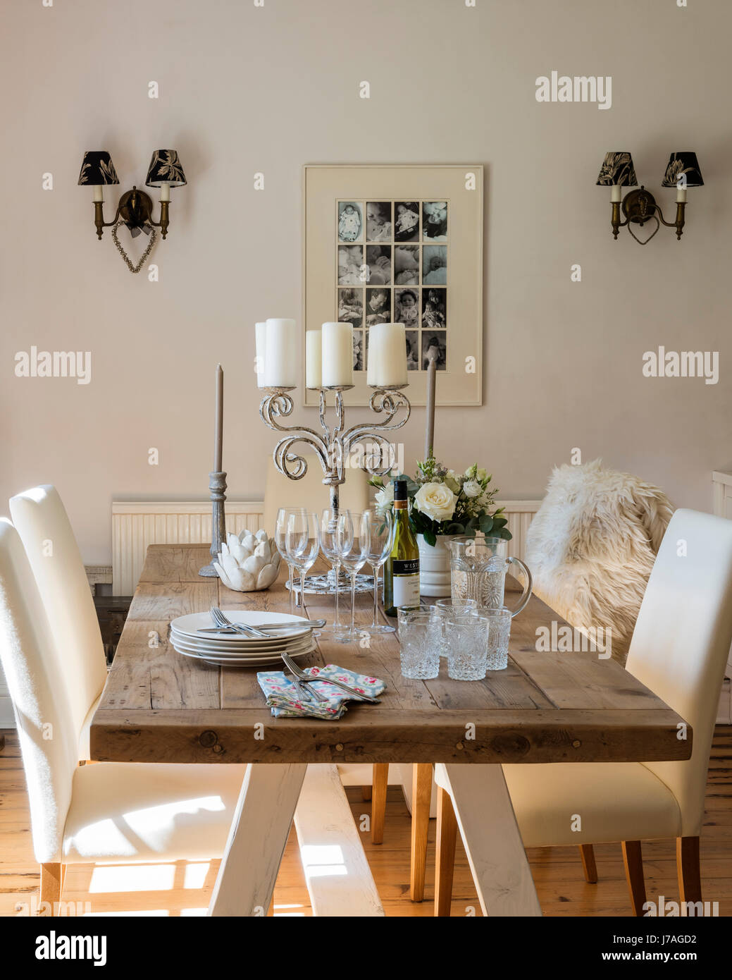 Airy dining room with large wooden table and wooden flooring. The ...