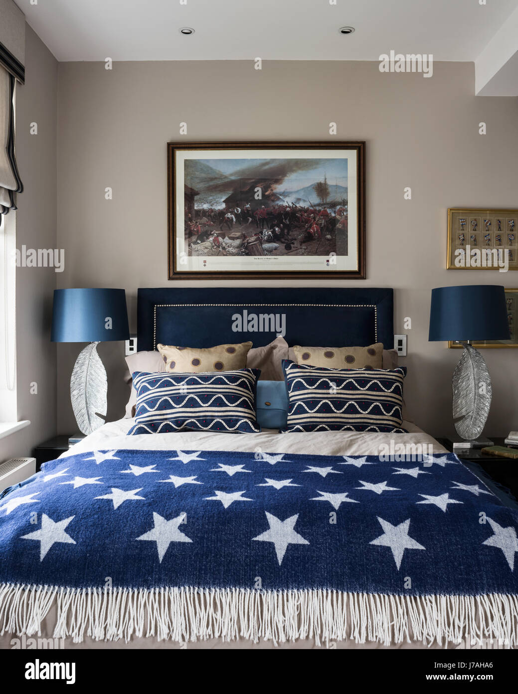 Nickel leaf table lamps with star bedspread and military artwork Stock ...
