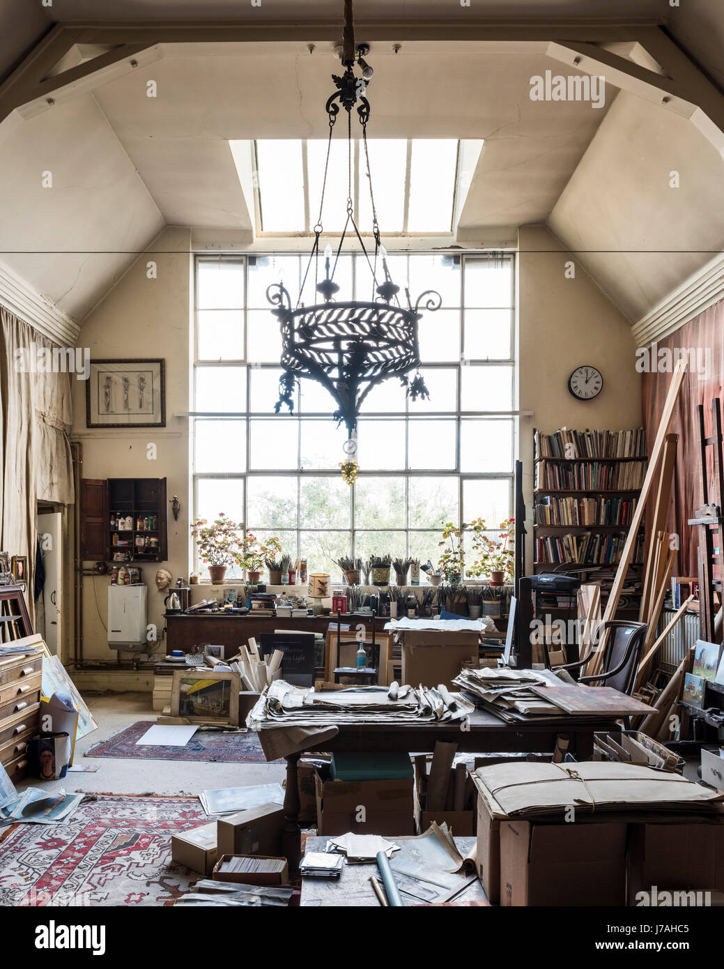 Huge window and skylight in large bohemian studio space with wrought ...