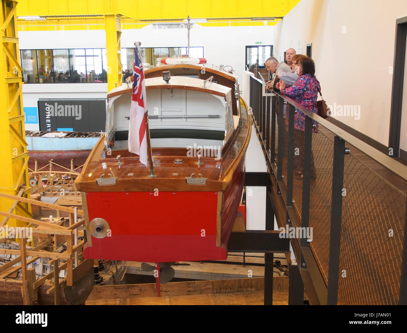 Visitors to Portsmouth historic dockyard view a boat in boathouse no 9 ...