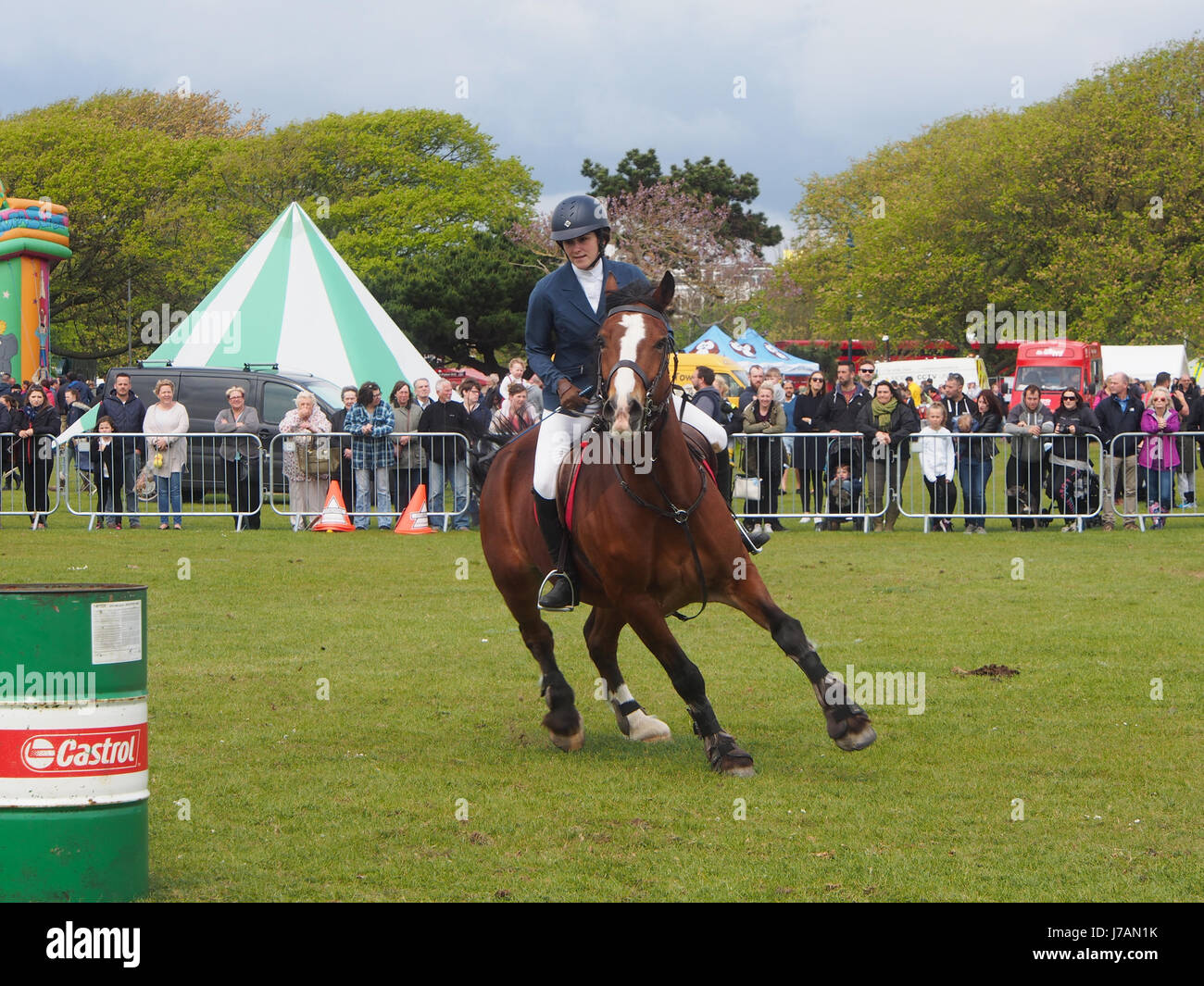 A teenager rides a horse during a barrel racing competition Stock Photo ...