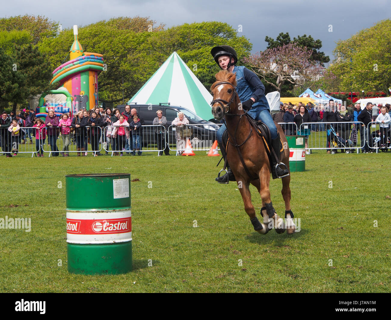 A teenager rides a horse during a barrel racing competition Stock Photo ...