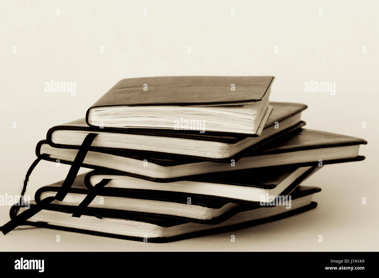 Stack of old leather covered diaries: black and white photo Stock Photo ...