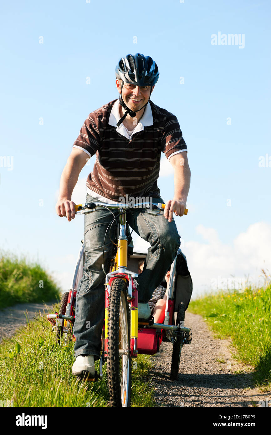 family riding bikes in summer Stock Photo - Alamy