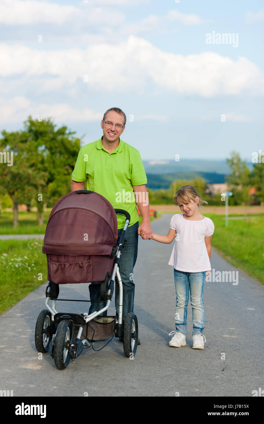 father with child and baby buggy Stock Photo - Alamy