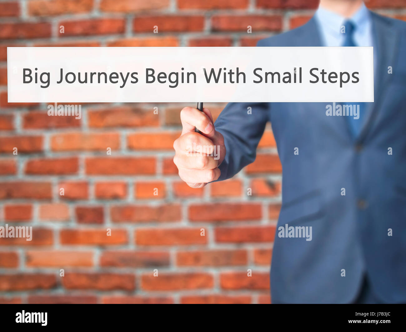 Big Journeys Begin With Small Steps - Businessman hand holding sign ...
