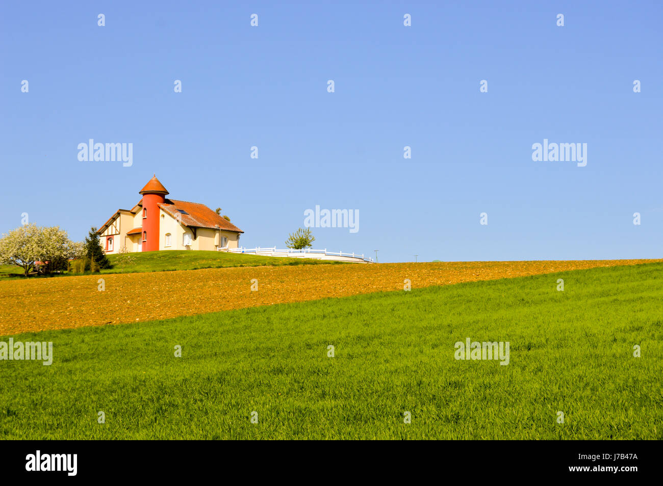 House with a turret over fields cultivated in the Meuse in France Stock ...