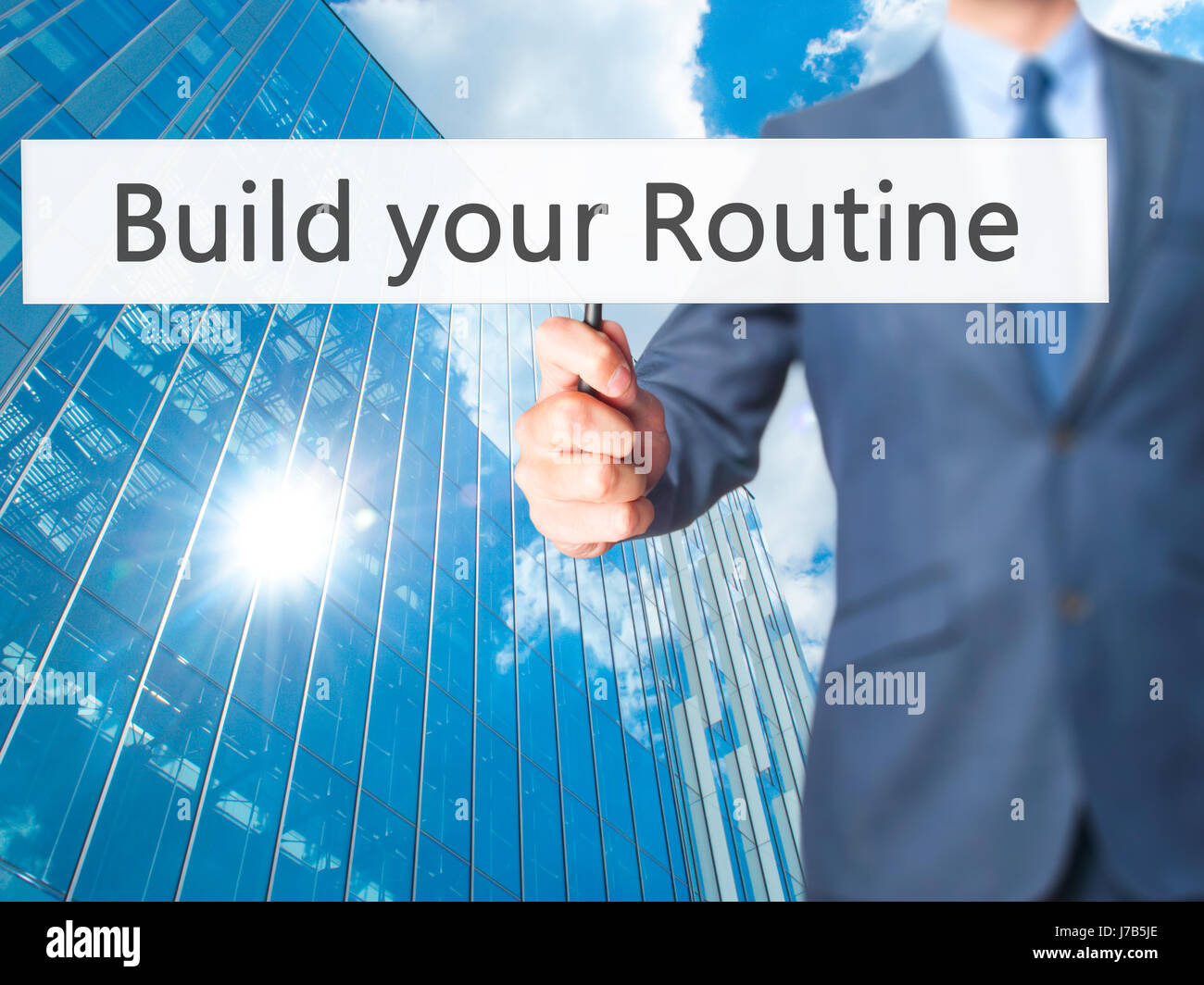 Build your Routine - Businessman hand holding sign. Business, technology, internet concept ...