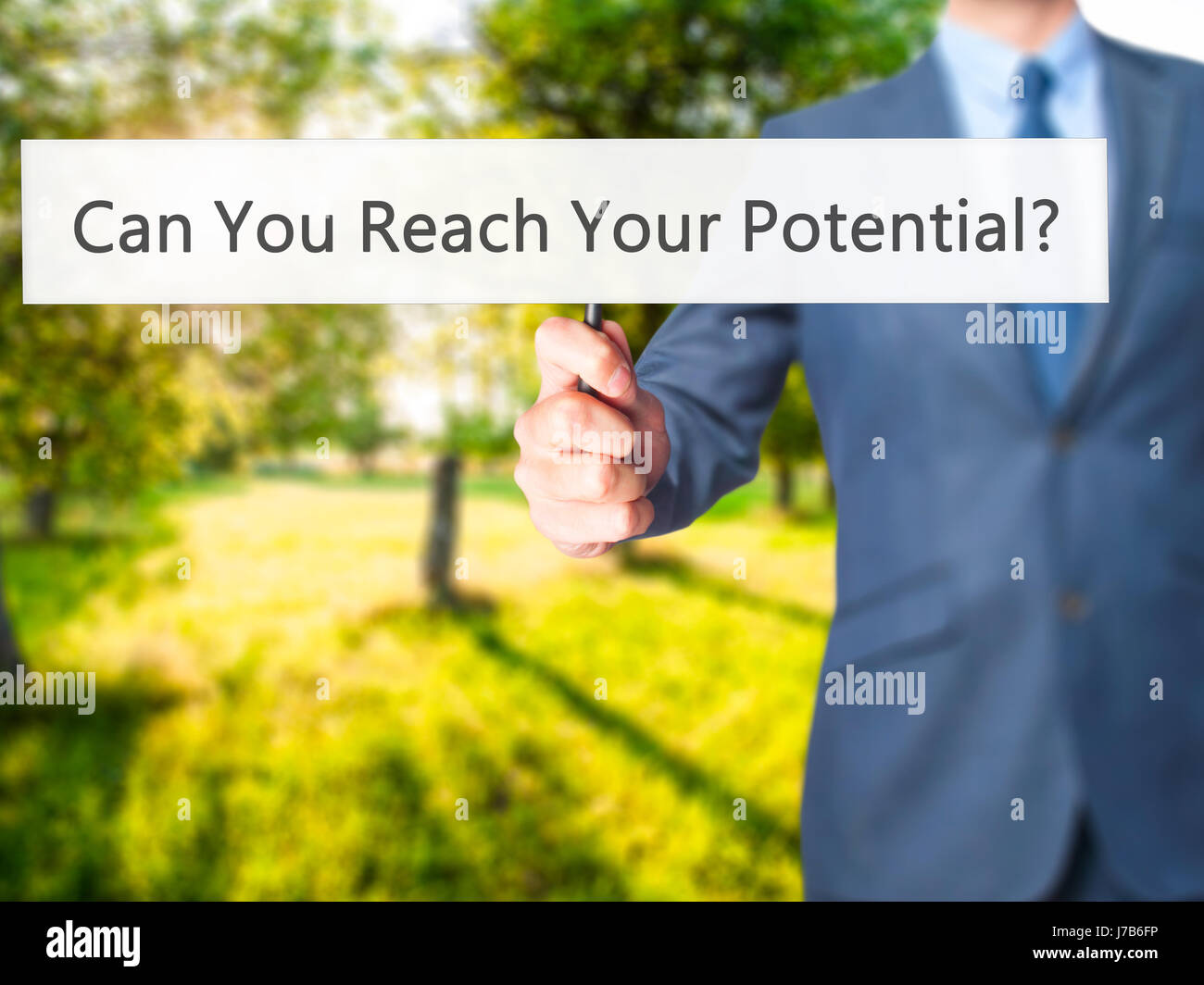 Can You Reach Your Potential ? - Business man showing sign. Business ...