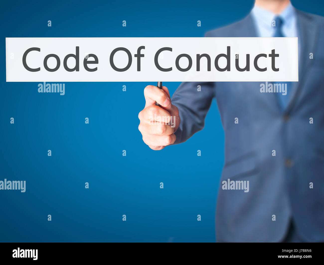 Code Of Conduct - Businessman hand holding sign. Business, technology ...