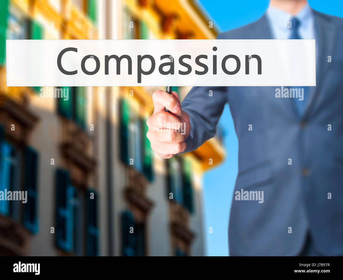 Compassion - Business man showing sign. Business, technology, internet ...