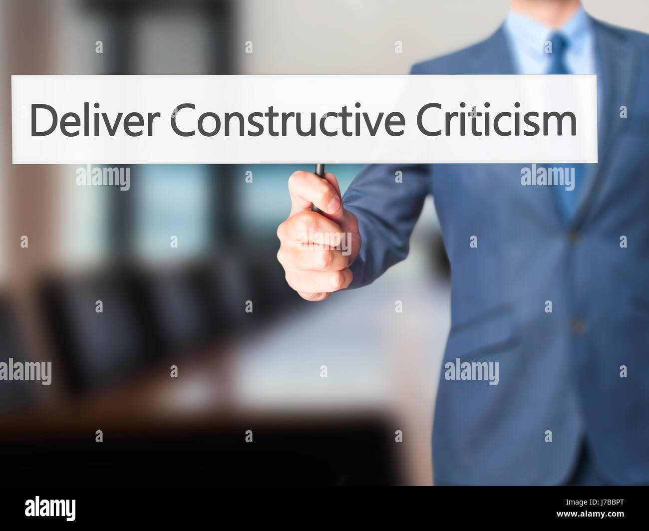Deliver Constructive Criticism - Businessman hand holding sign. Business, technology, internet ...