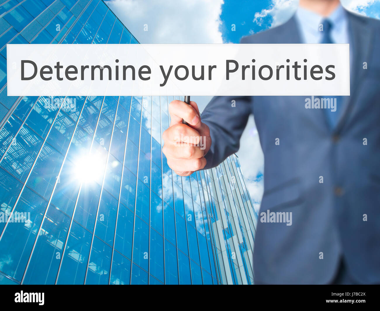Determine your Priorities - Businessman hand holding sign. Business ...
