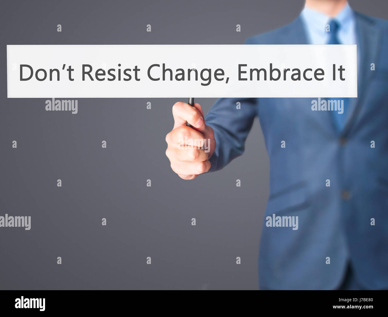 Don't Resist Change, Embrace It! - Businessman hand holding sign ...