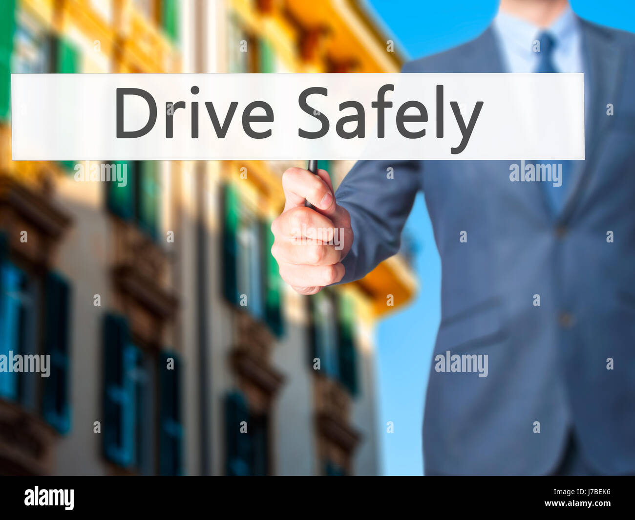 Drive Safely - Businessman hand holding sign. Business, technology ...