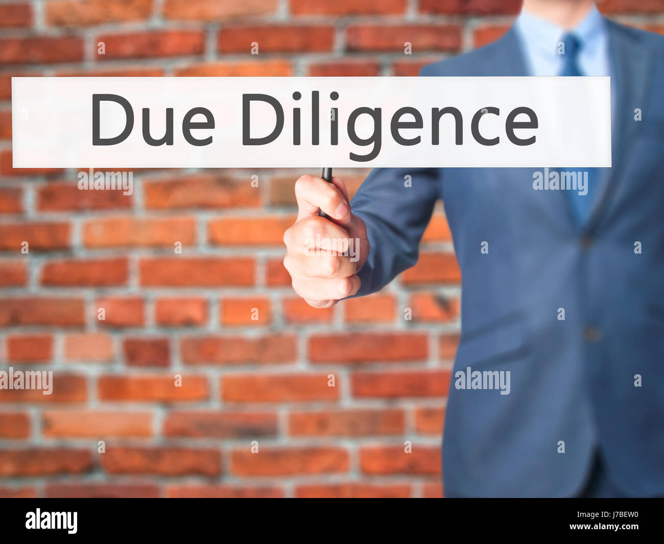 Due Diligence - Businessman hand holding sign. Business, technology ...