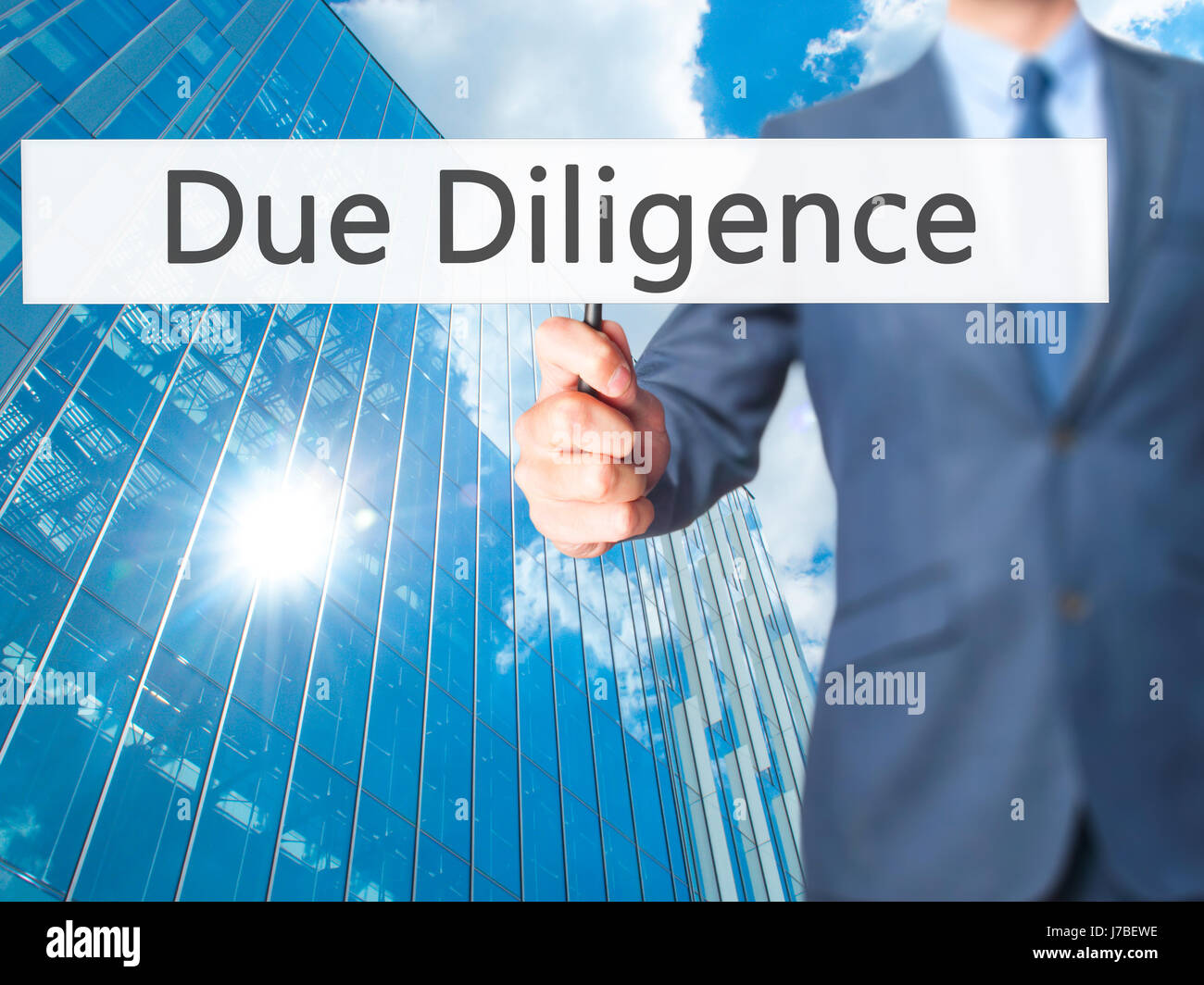 Due Diligence - Businessman hand holding sign. Business, technology ...